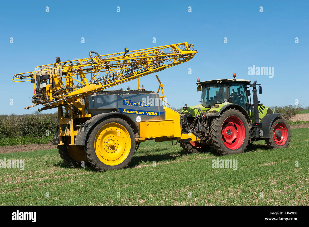 Farm crop sprayer being towed behind tractor Stock Photo - Alamy