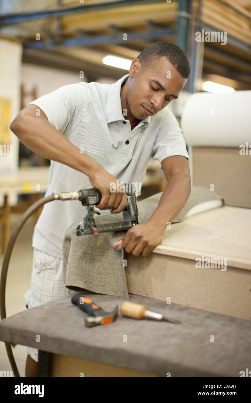 Upholsterer attaching textile frame using hi-res stock photography and ...