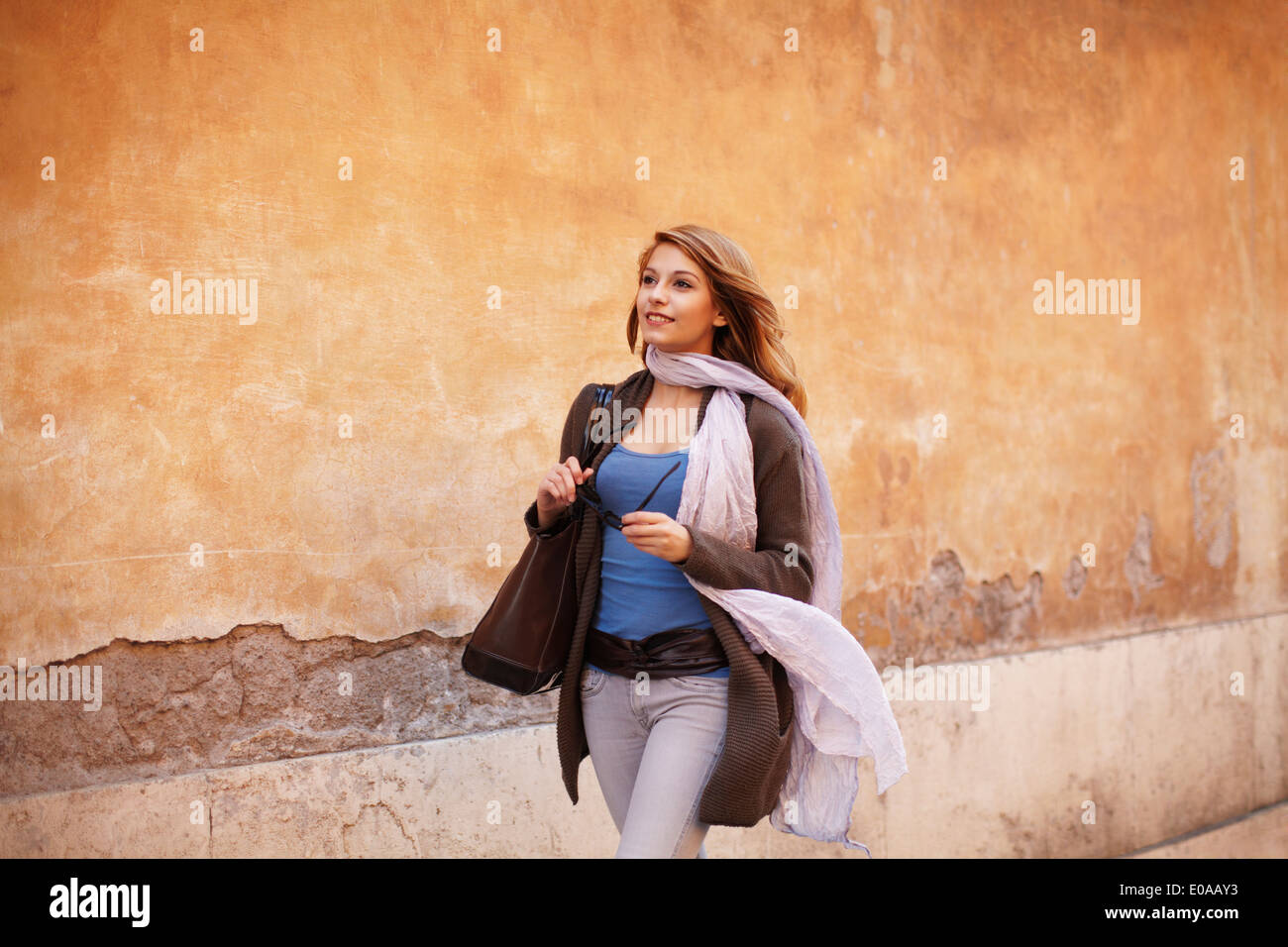 Young woman strolling down street hi-res stock photography and images ...