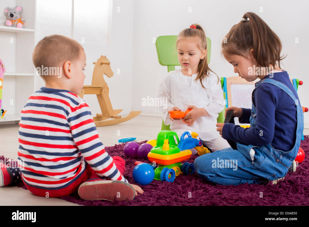 Kids playing in the room Stock Photo - Alamy