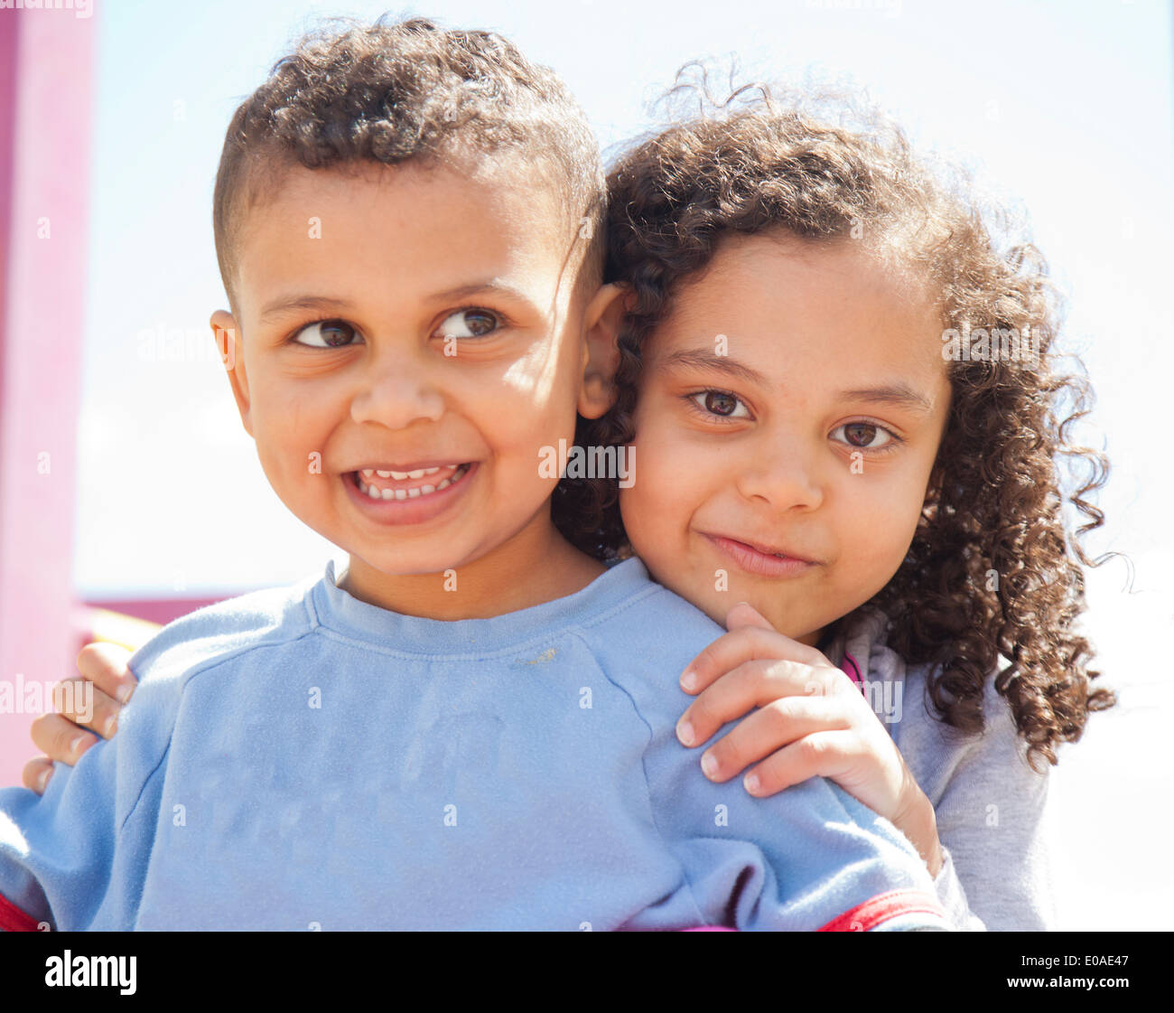 mixed race brother and sister hugging and smiling Stock Photo - Alamy