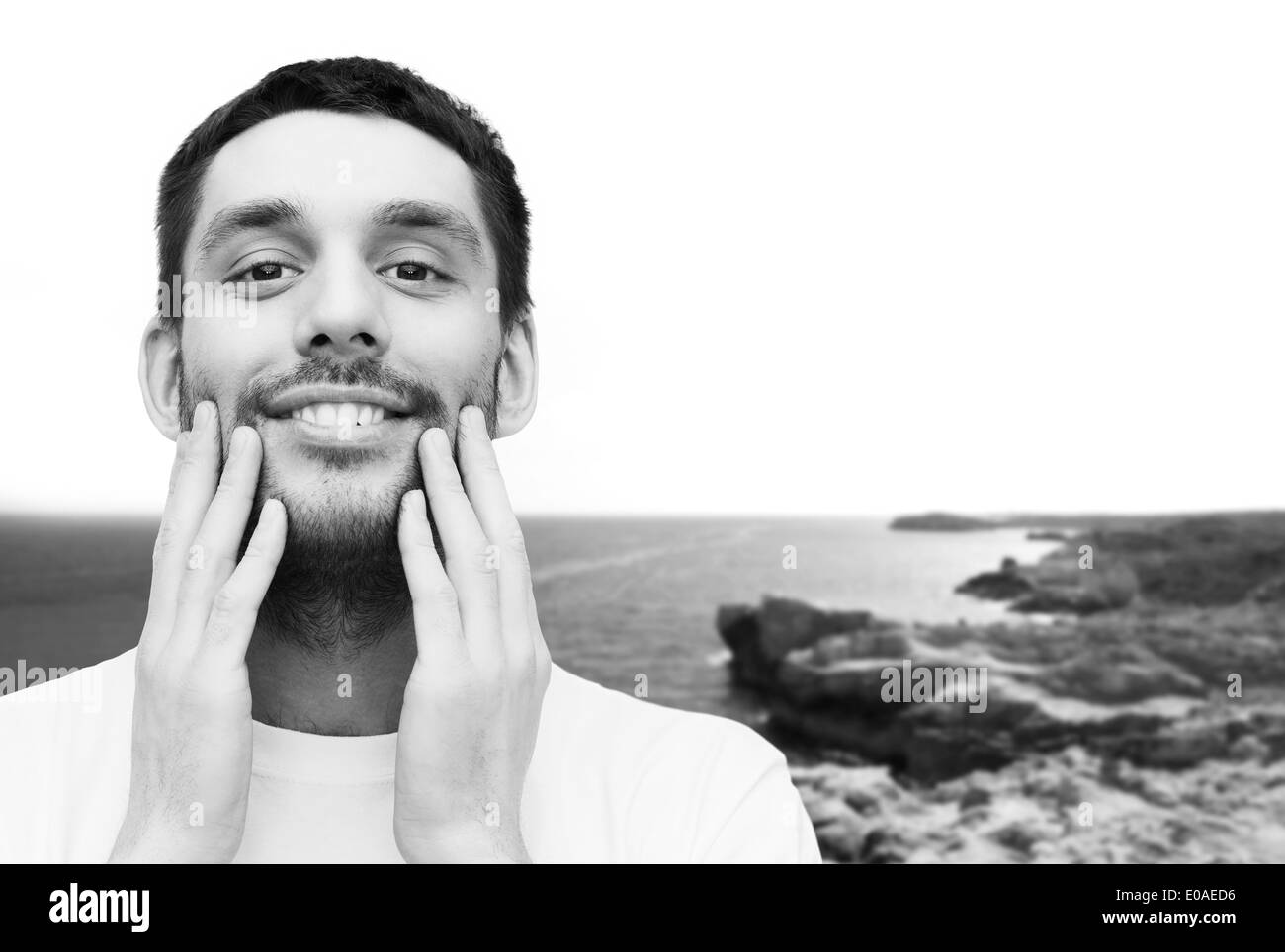 beautiful smiling man touching his face Stock Photo - Alamy