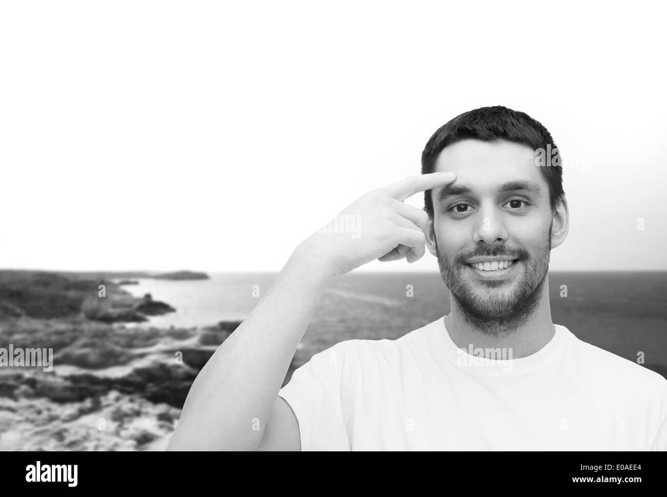 smiling young handsome man pointing to forehead Stock Photo - Alamy
