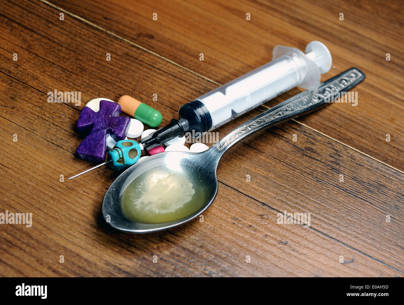 Drug abuse- syringe , spoon,skul,cross and lighter on the floor Stock ...