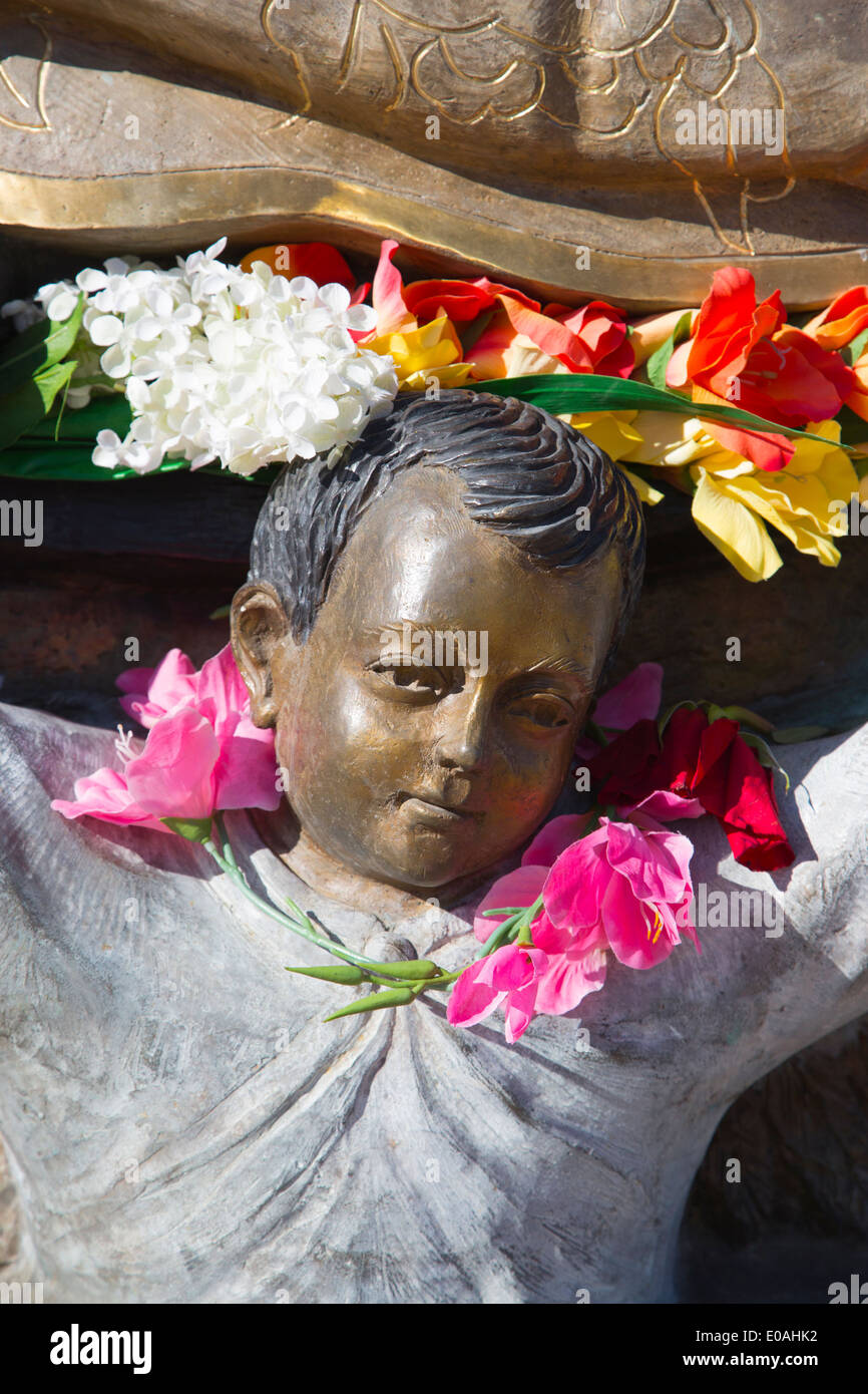 Closeup detail of Shrine of Our Lady of Guadalupe statue adorned with ...