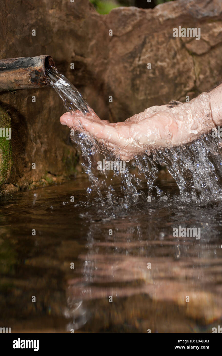 Water falling over hand Stock Photo - Alamy