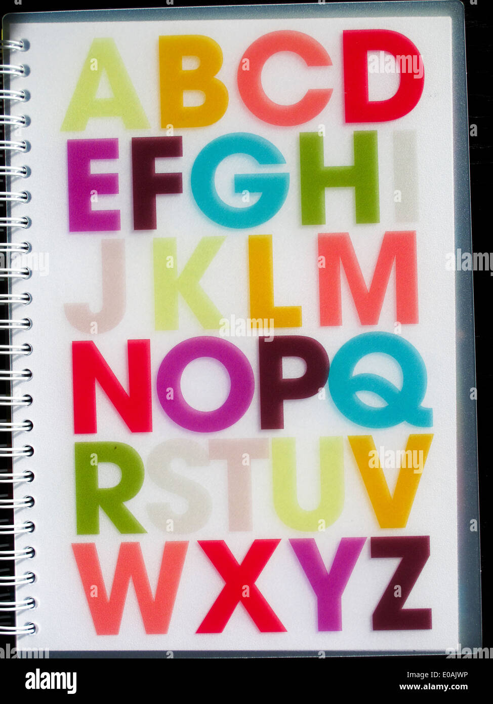 Coloured alphabet letters on cover of notebook Stock Photo - Alamy