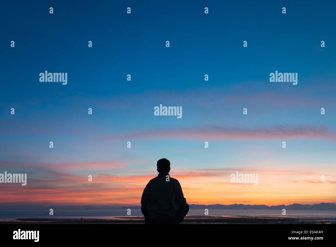 One man yoga sitting sunset beach hi-res stock photography and images ...