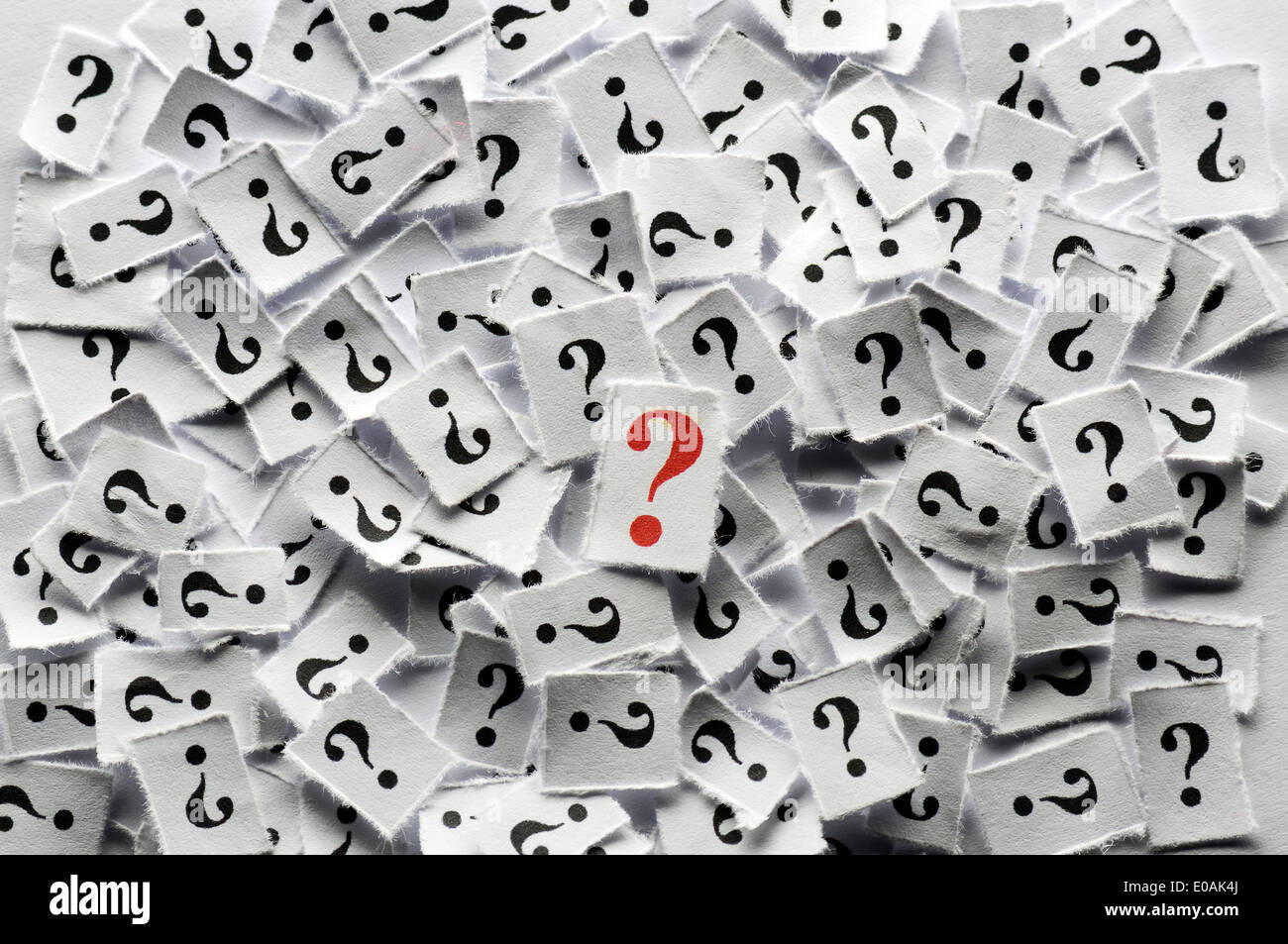 lot of question marks on white papers -hard light Stock Photo - Alamy