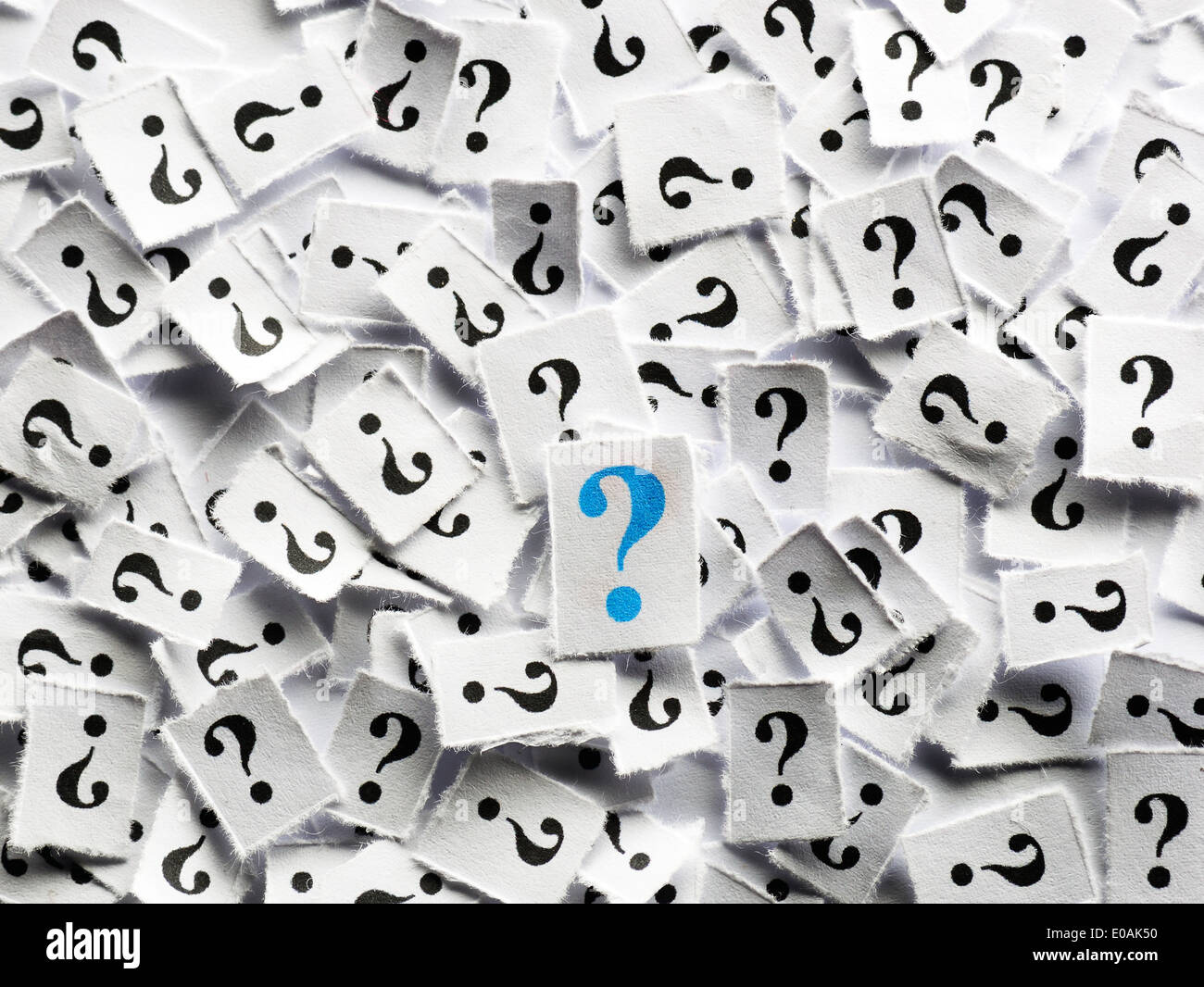 lot of question marks on white papers -hard light Stock Photo - Alamy