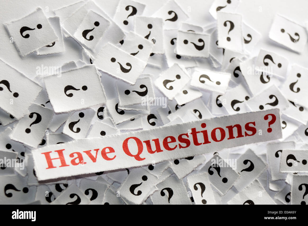 lot of question marks on white papers -hard light Stock Photo - Alamy