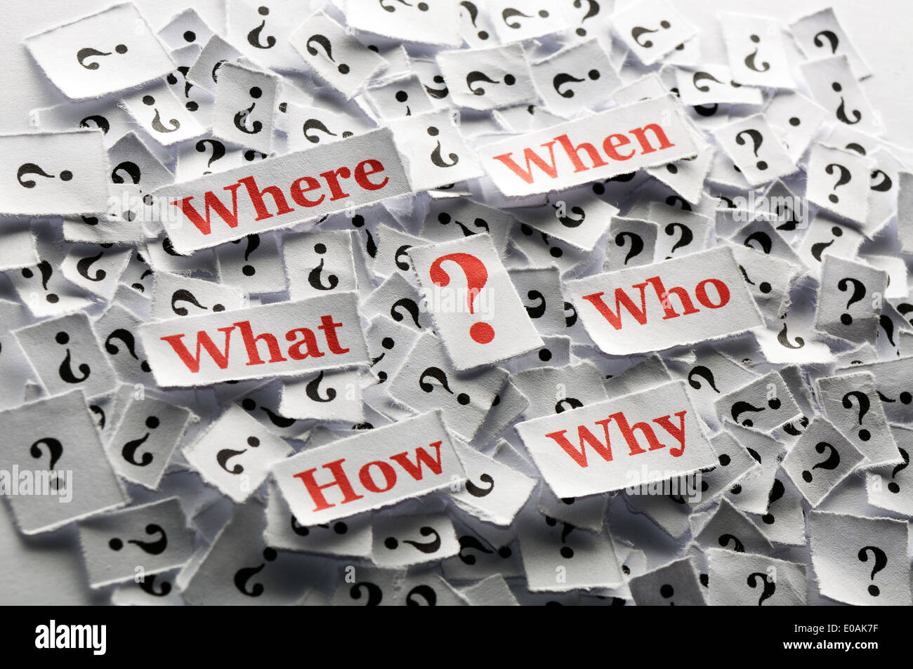 lot of question marks on white papers -hard light Stock Photo - Alamy