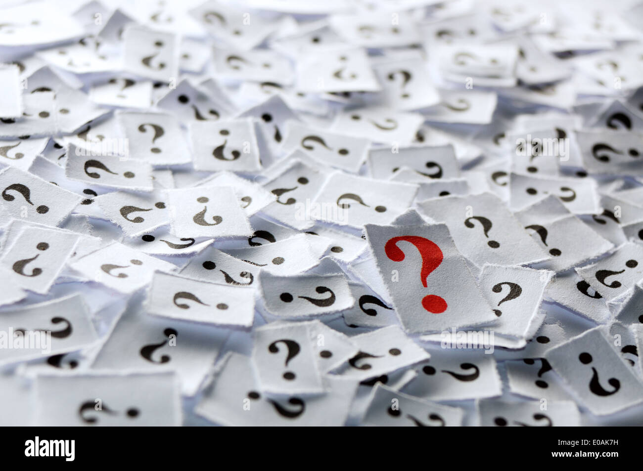 lot of question marks on white papers -hard light Stock Photo - Alamy