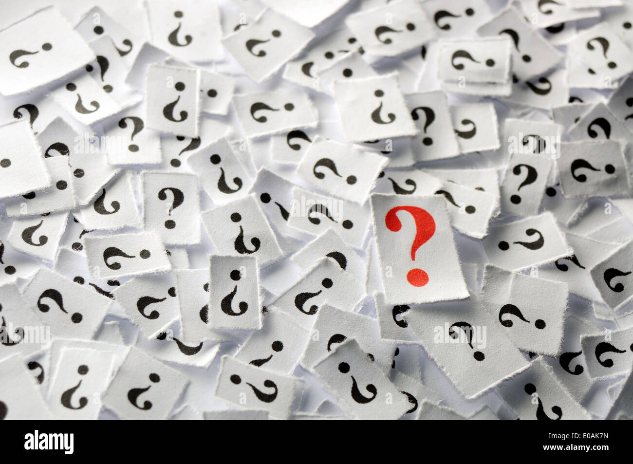 lot of question marks on white papers -hard light Stock Photo - Alamy