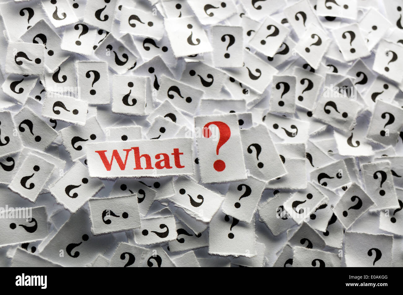 what on question marks on white papers -hard light Stock Photo - Alamy
