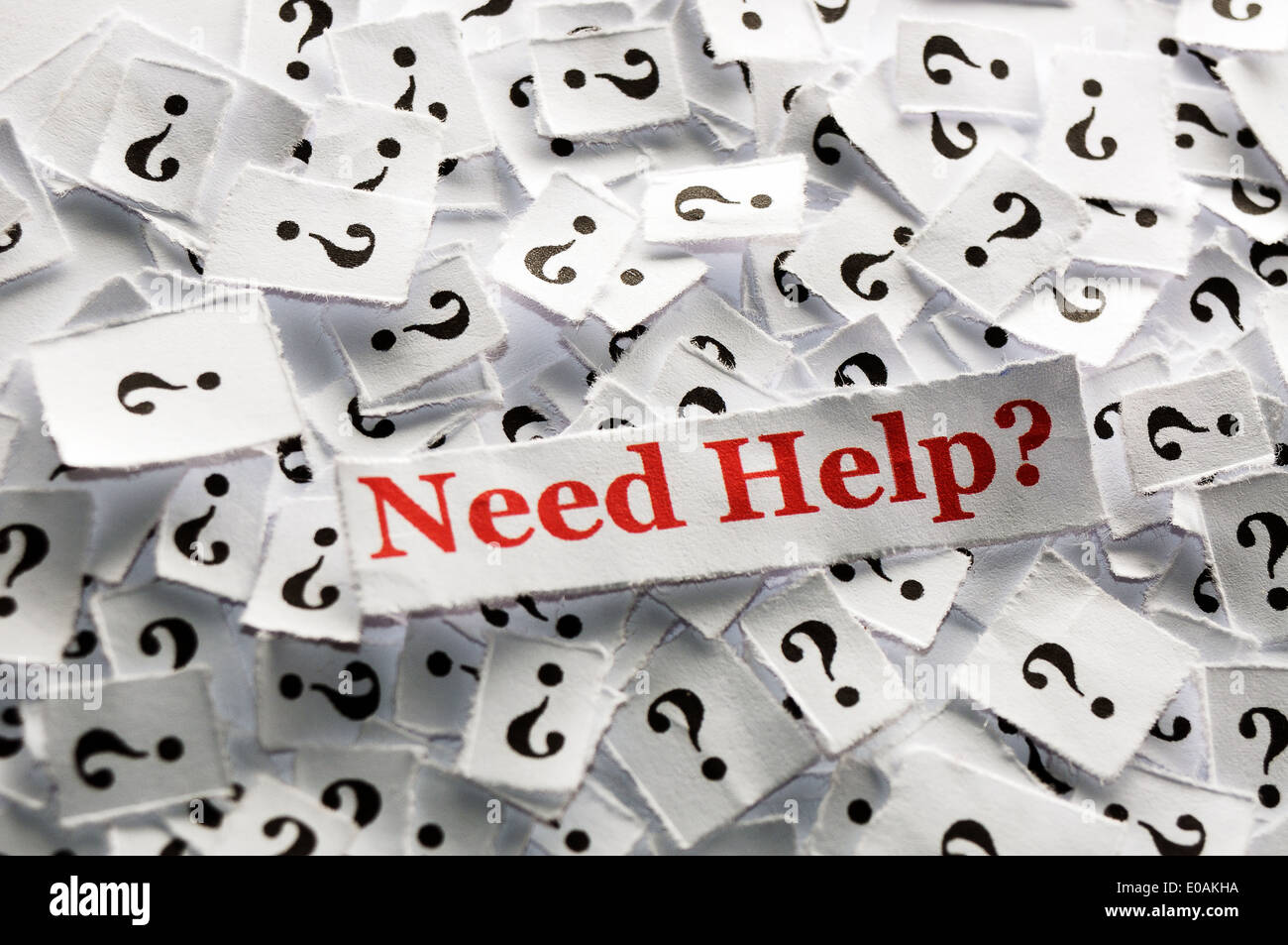 need help question marks on white papers -hard light Stock Photo - Alamy