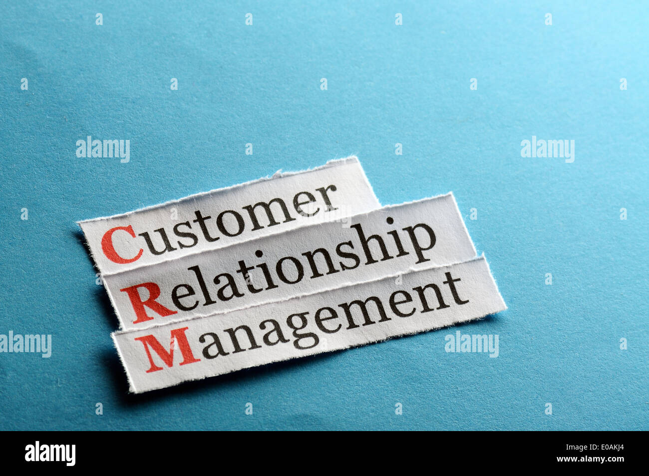 CRM customer relation management abbreviation on blue paper Stock Photo ...