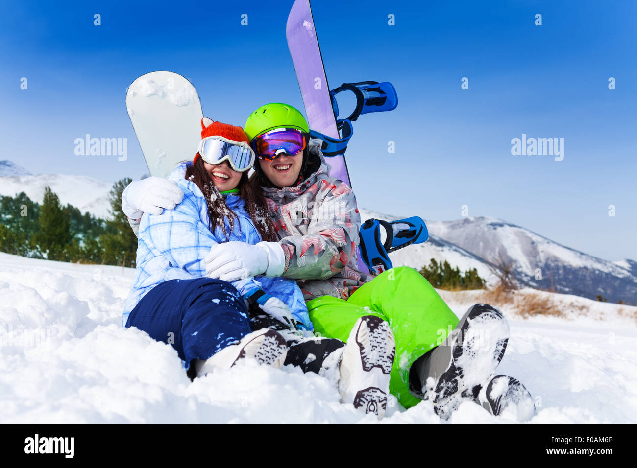 Cuddling couple sitting close to each other Stock Photo - Alamy