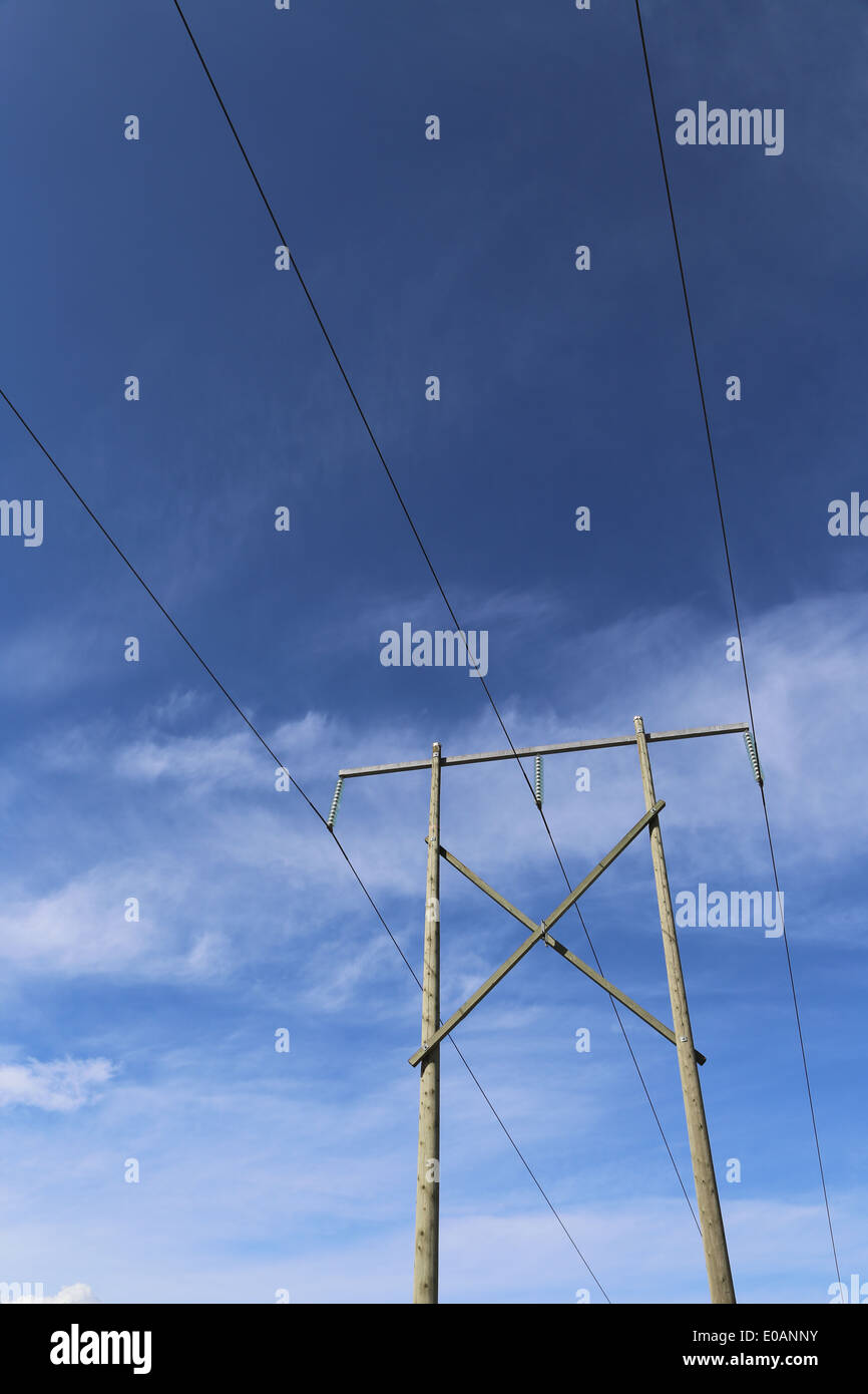 High voltage power transmission lines against blue sky Stock Photo - Alamy