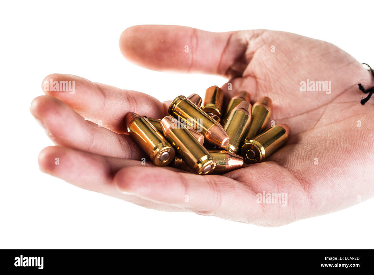 a heap of 9mm pistol bullets holded by human hands isolated over a ...