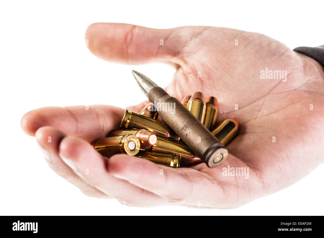 a heap of 9mm pistol bullets holded by human hands isolated over a ...