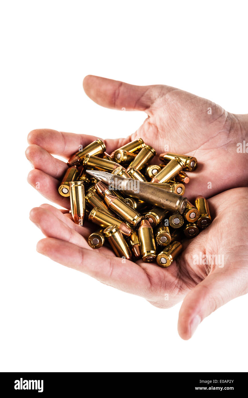 a heap of 9mm pistol bullets holded by human hands isolated over a ...
