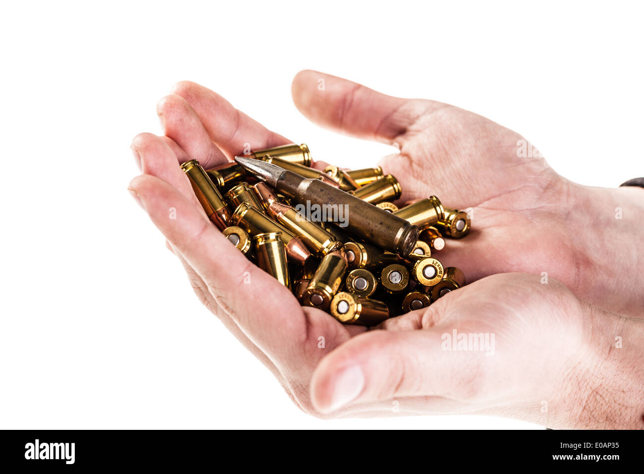 a heap of 9mm pistol bullets holded by human hands isolated over a ...