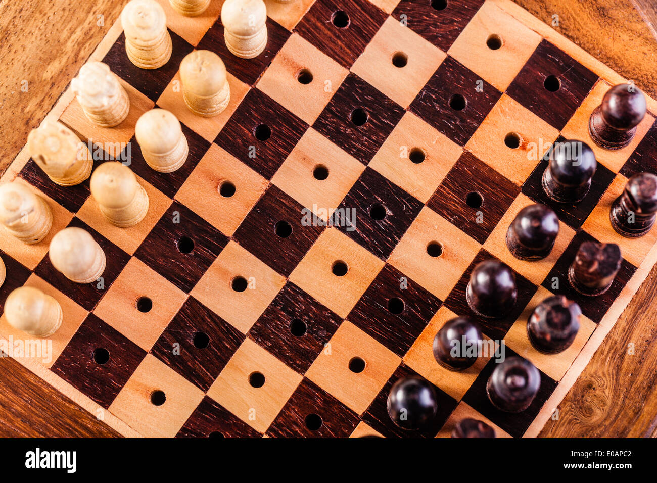 a small wooden chess board with chess pieces Stock Photo - Alamy