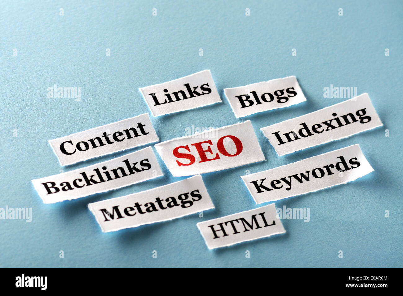 SEO Word Cloud printed on paper on blue Stock Photo - Alamy
