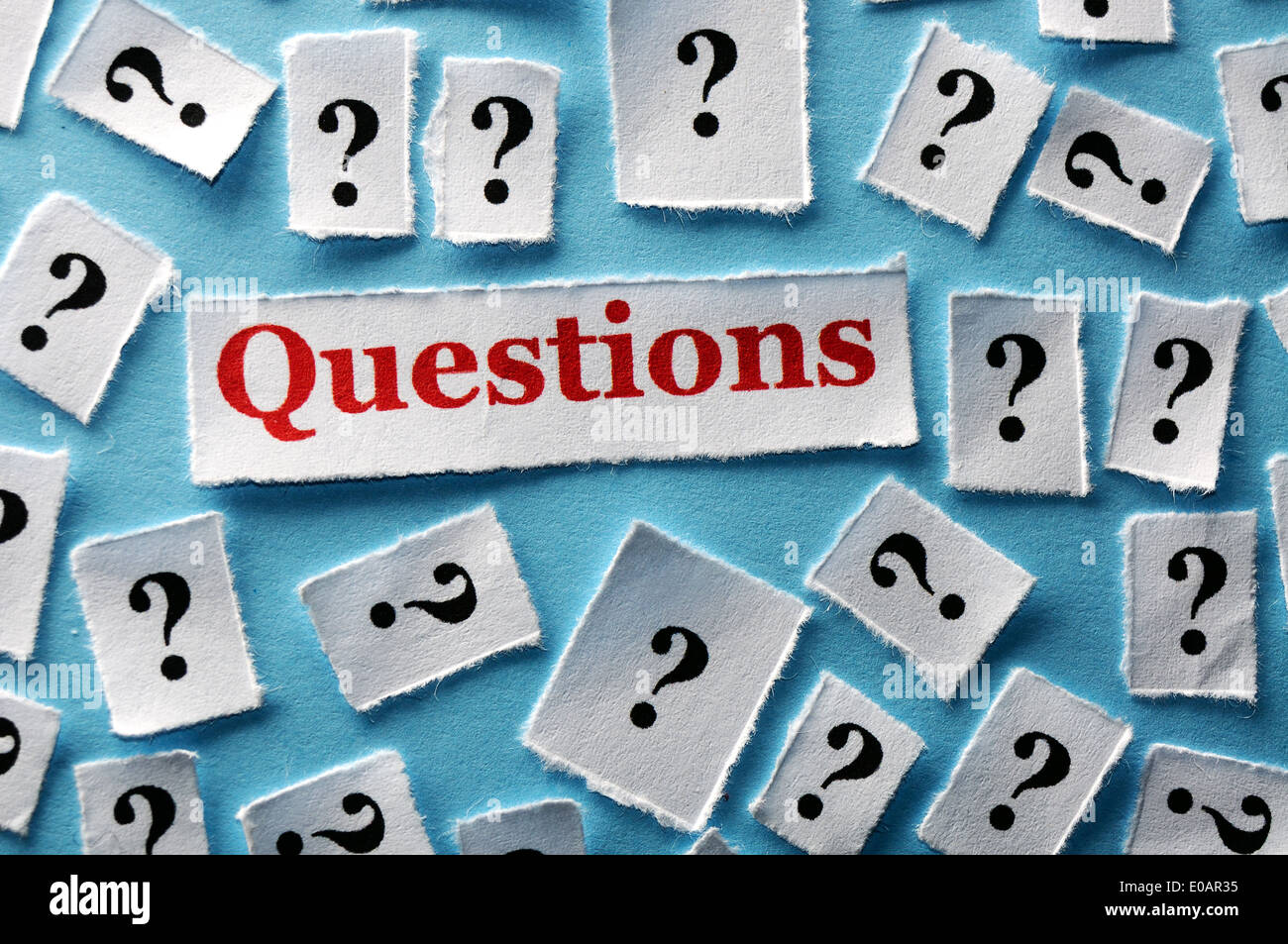 lot of question marks on white papers -hard light Stock Photo - Alamy