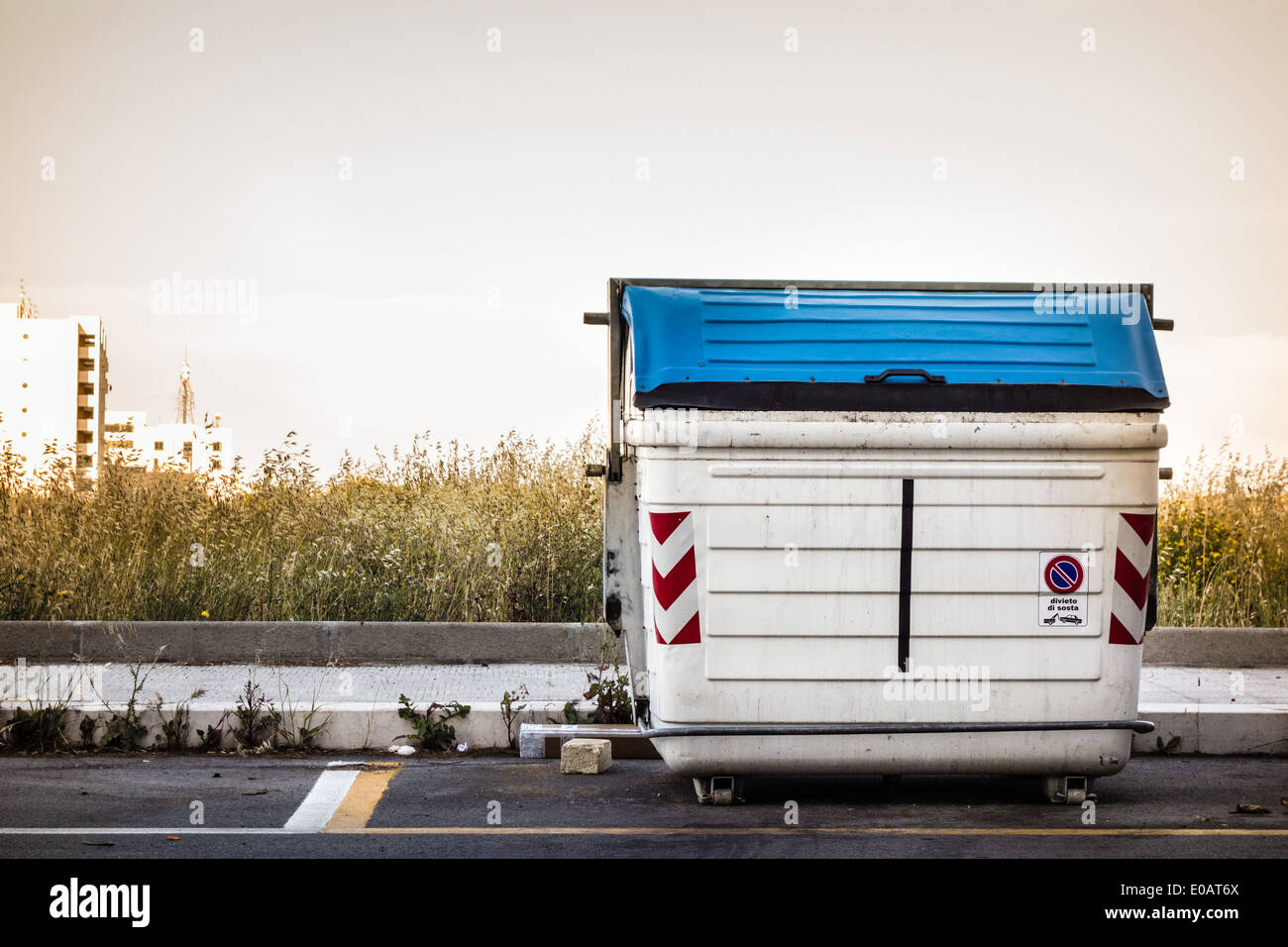 a white and weathered dumpster at the street side Stock Photo - Alamy