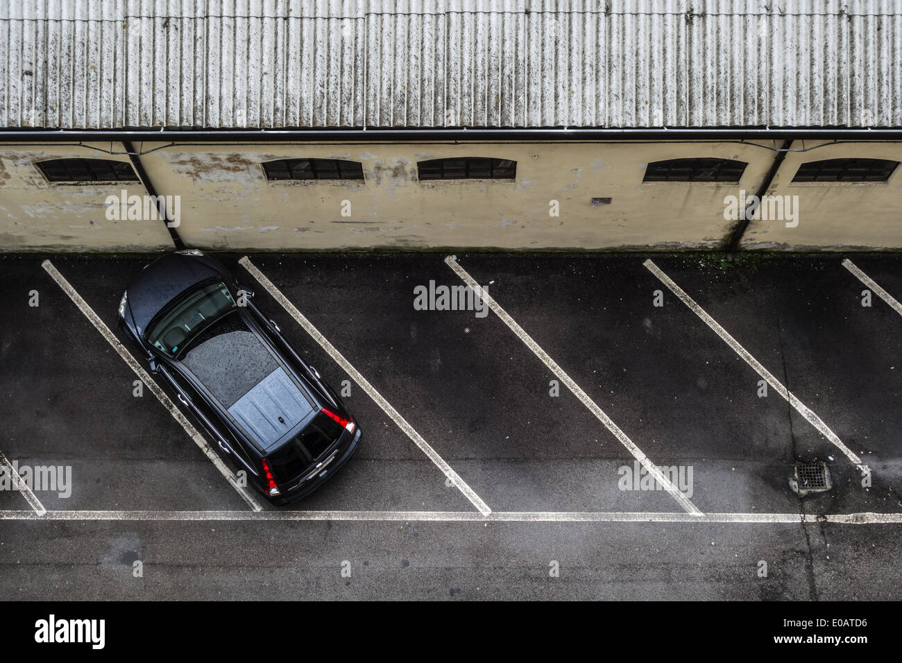 a small parking lot seen from above, with only one car Stock Photo - Alamy
