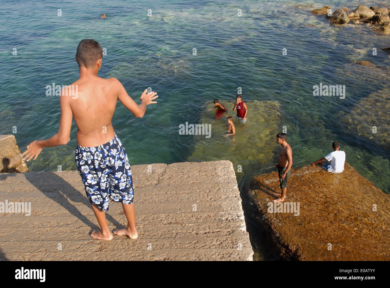 Tunisia, bathing young people on waterfront of Tabarka town Stock Photo ...