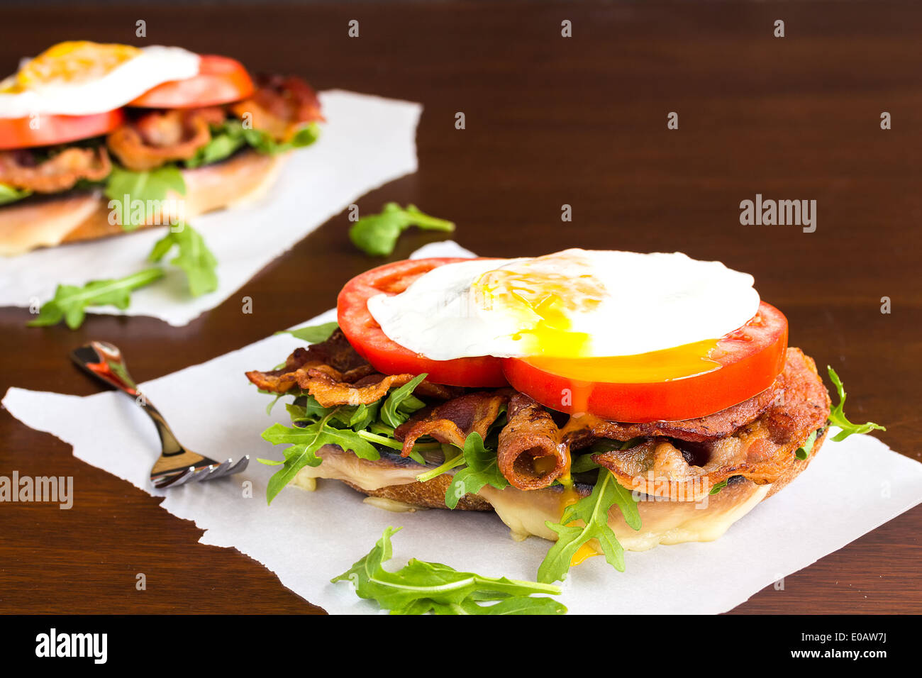 Open-faced BLT sandwich with provolone cheese, arugula, bacon, tomato ...