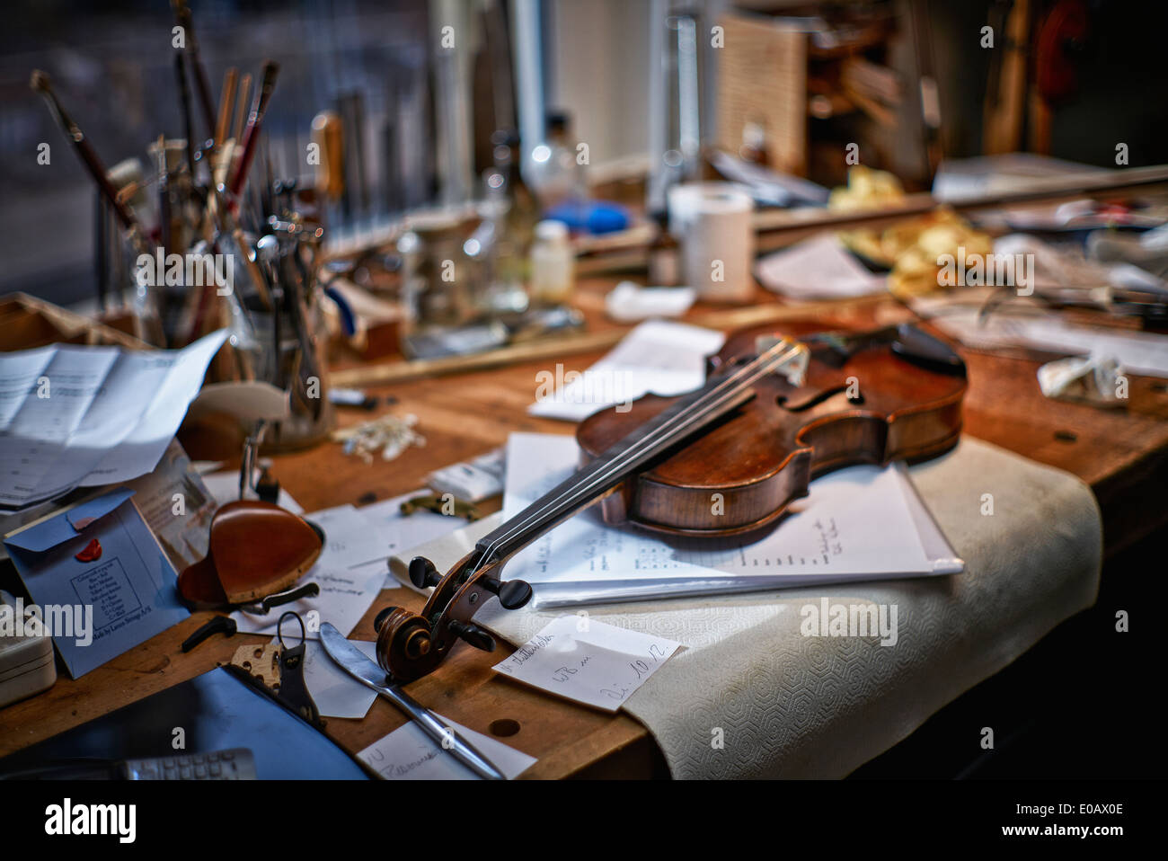 Tools and damaged instruments in a violin maker's workshop Stock Photo ...