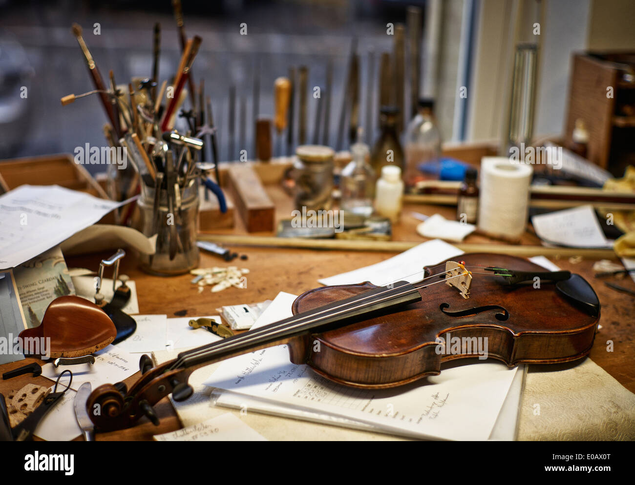 Tools and damaged instruments in a violin maker's workshop Stock Photo ...
