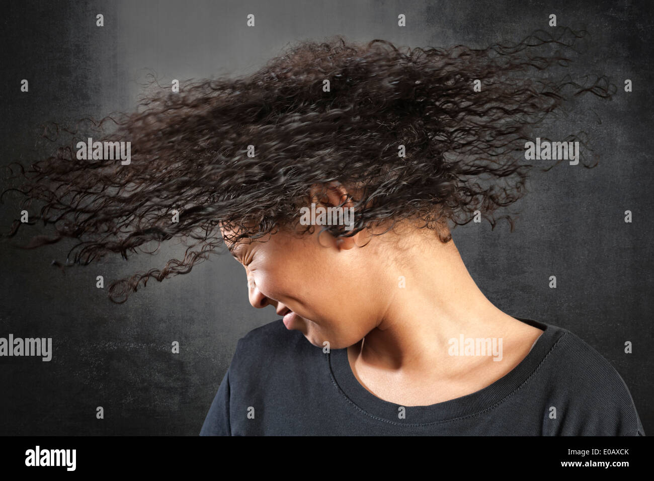 Portrait of young girl tossing hair Stock Photo - Alamy