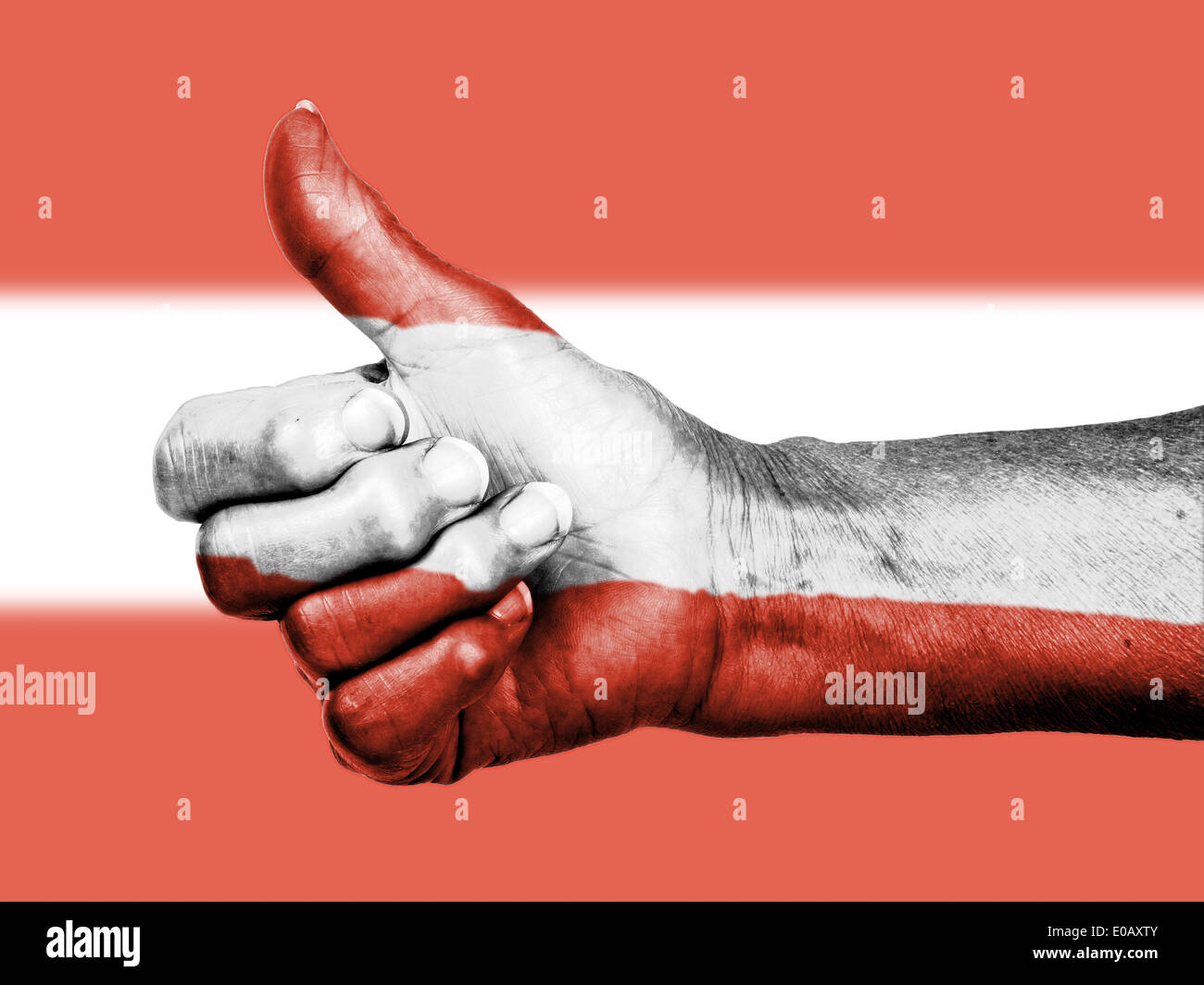 Old woman with arthritis giving the thumbs up sign wrapped in flag ...