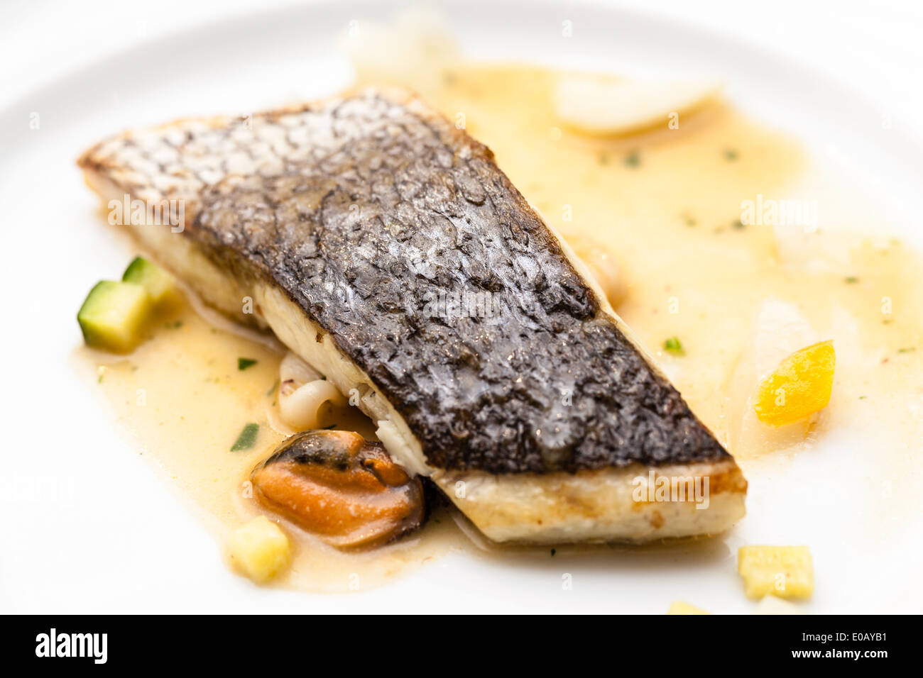 delicious fish fillet in a plate cooked with some vegetables Stock ...