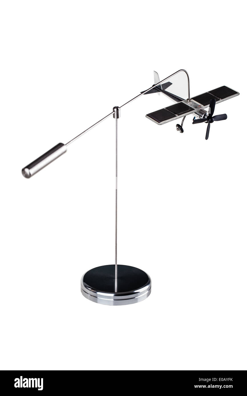 a metal toy plane with solar panels isolated over a white background ...