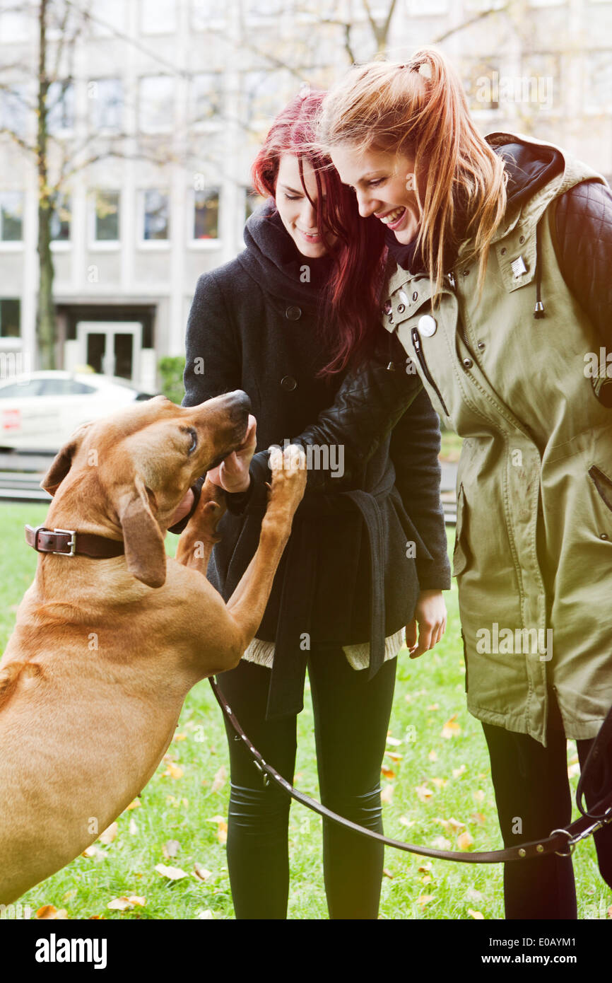 Two women with dog Stock Photo - Alamy