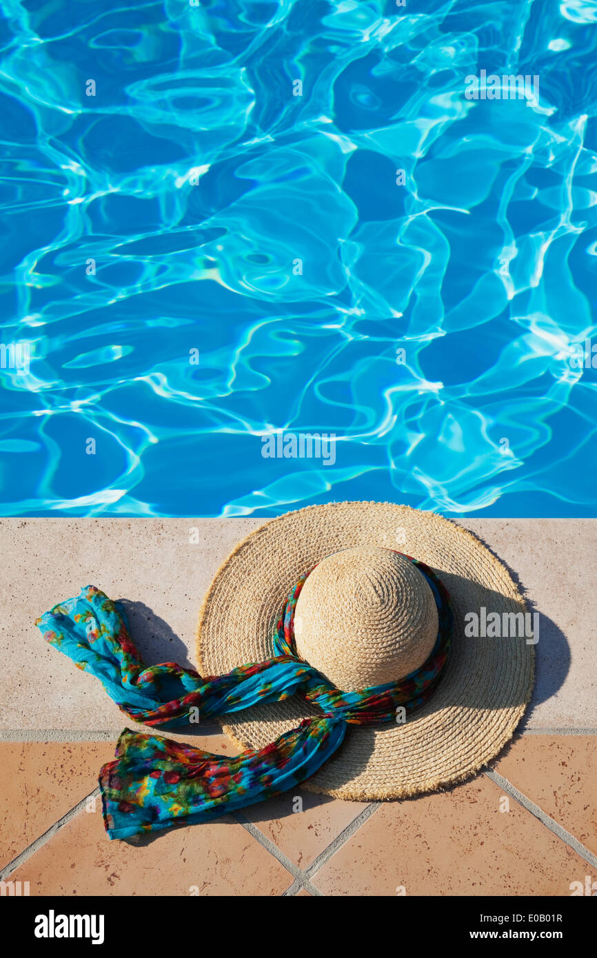 Straw hat lying at pool edge Stock Photo - Alamy