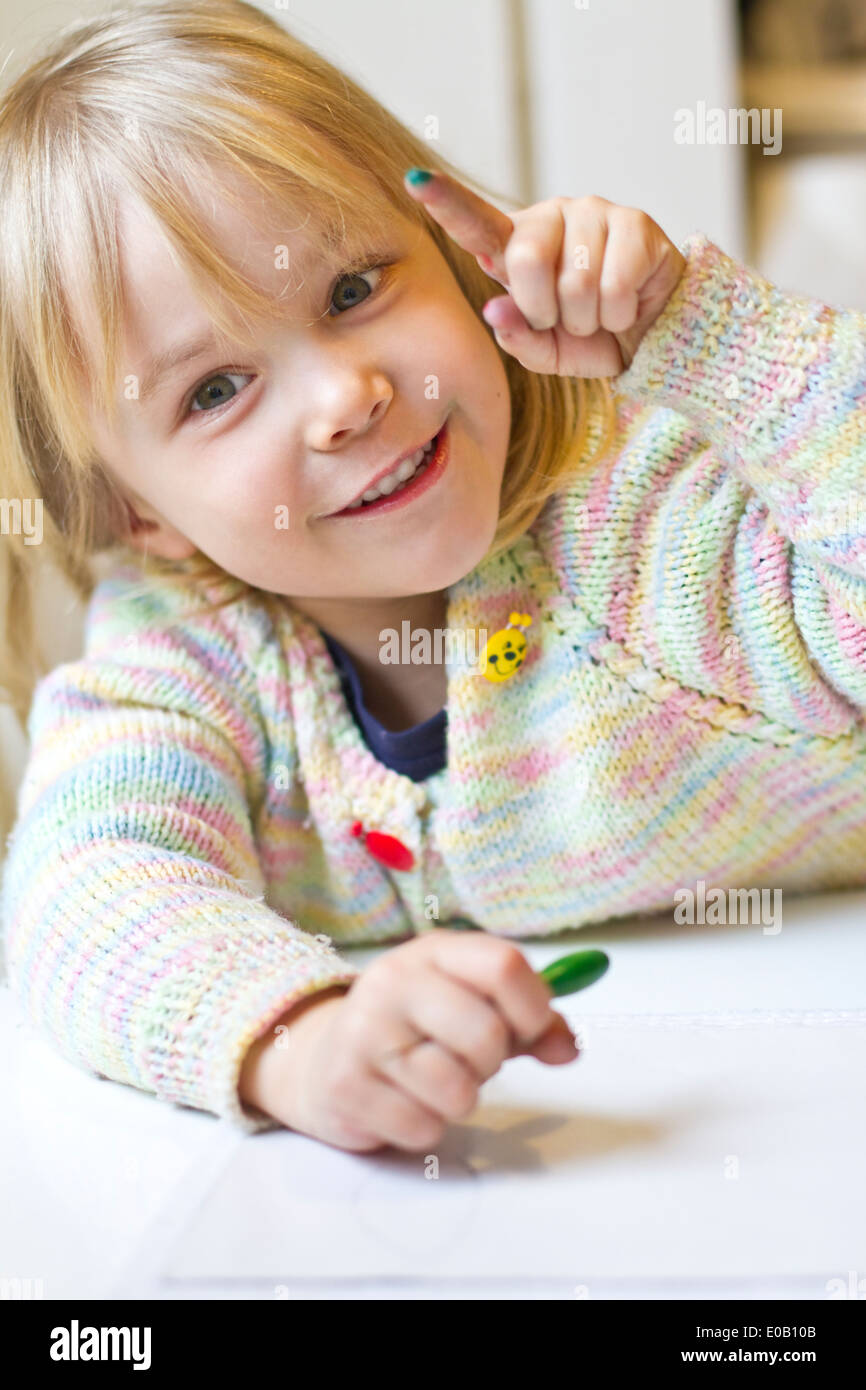 Portrait of smiling little girl showing finger full of colour Stock ...