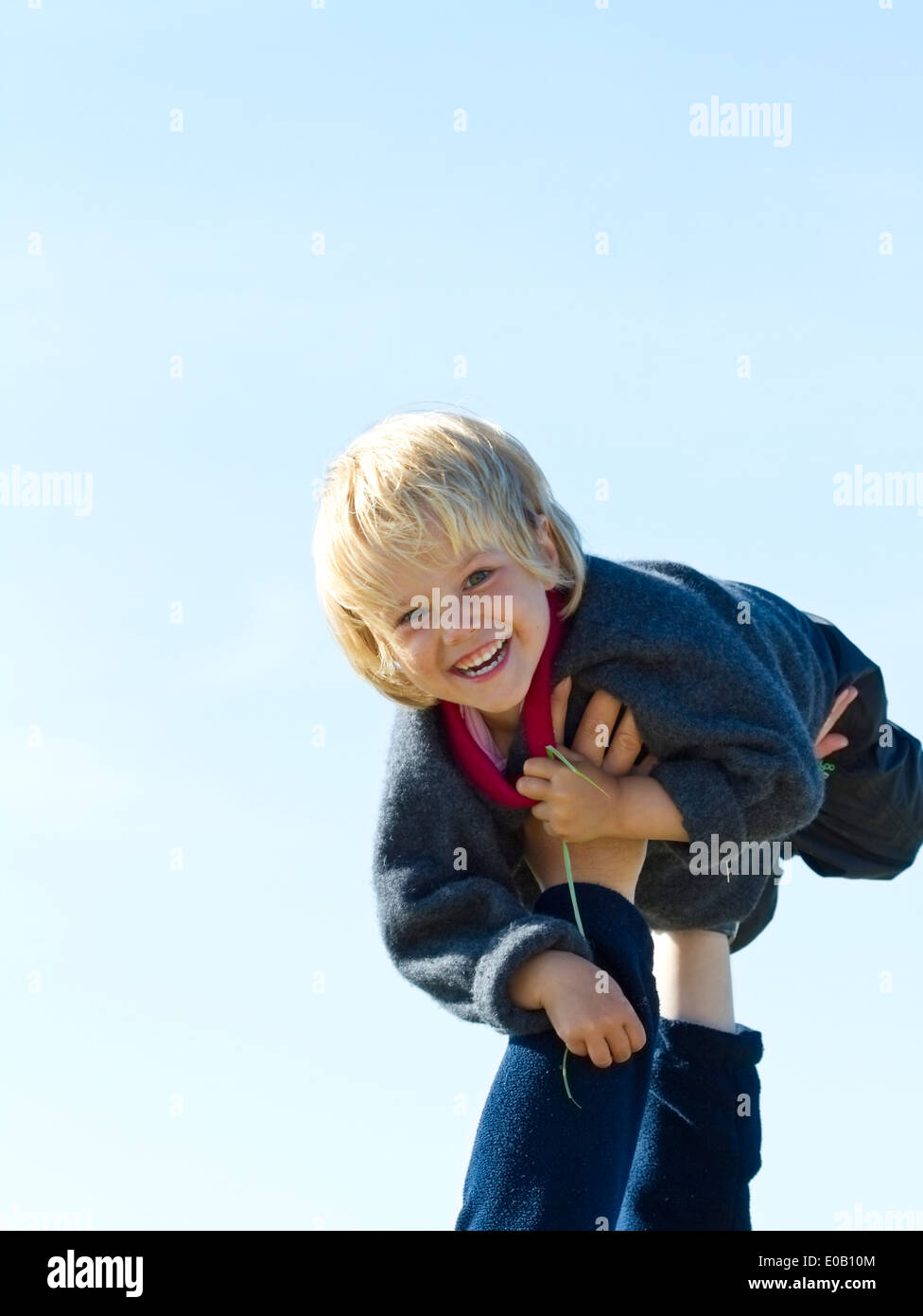 Little girl holding aloft of father Stock Photo - Alamy