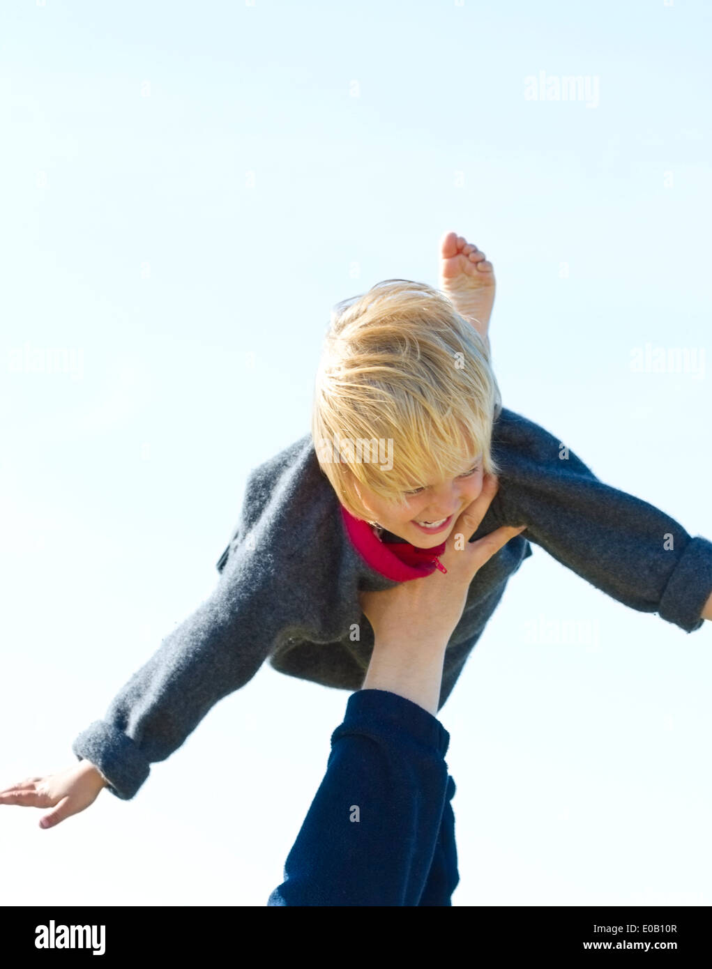 Little girl holding aloft of father Stock Photo - Alamy