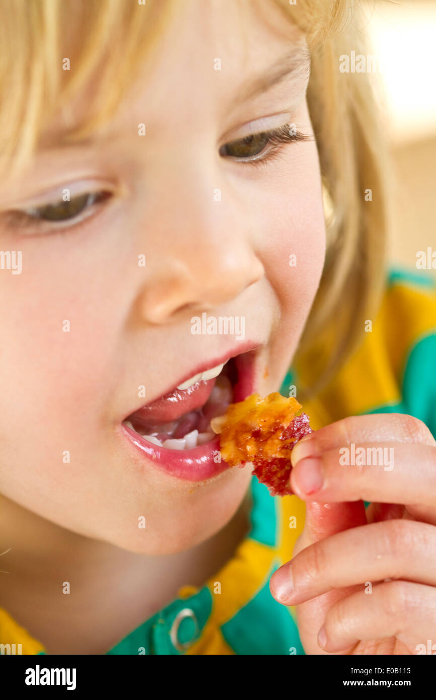Portrait of little girl eating, close-up Stock Photo - Alamy