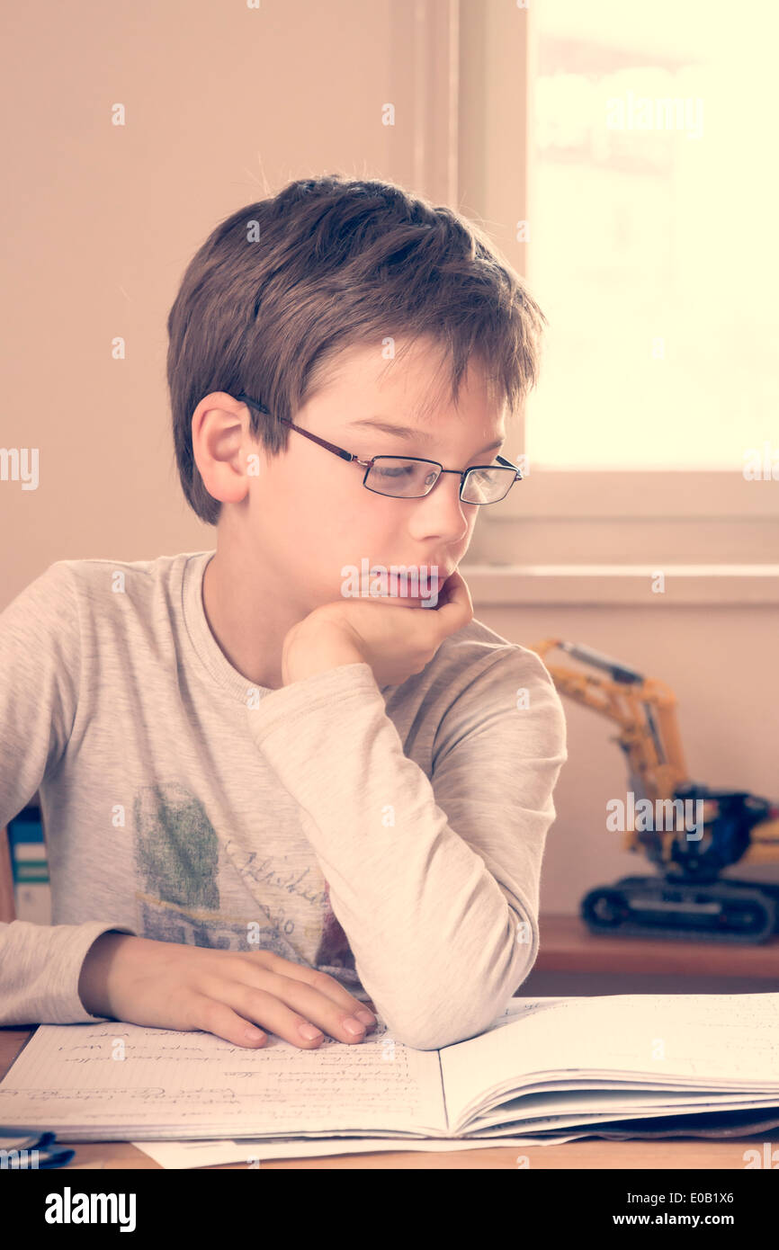 Portrait of little boy doing homework Stock Photo - Alamy