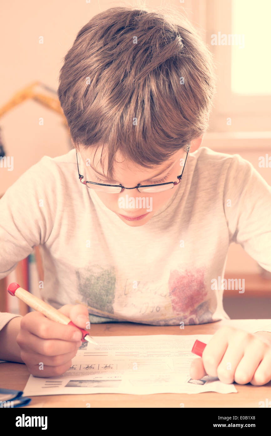 Portrait of little boy doing homework Stock Photo - Alamy