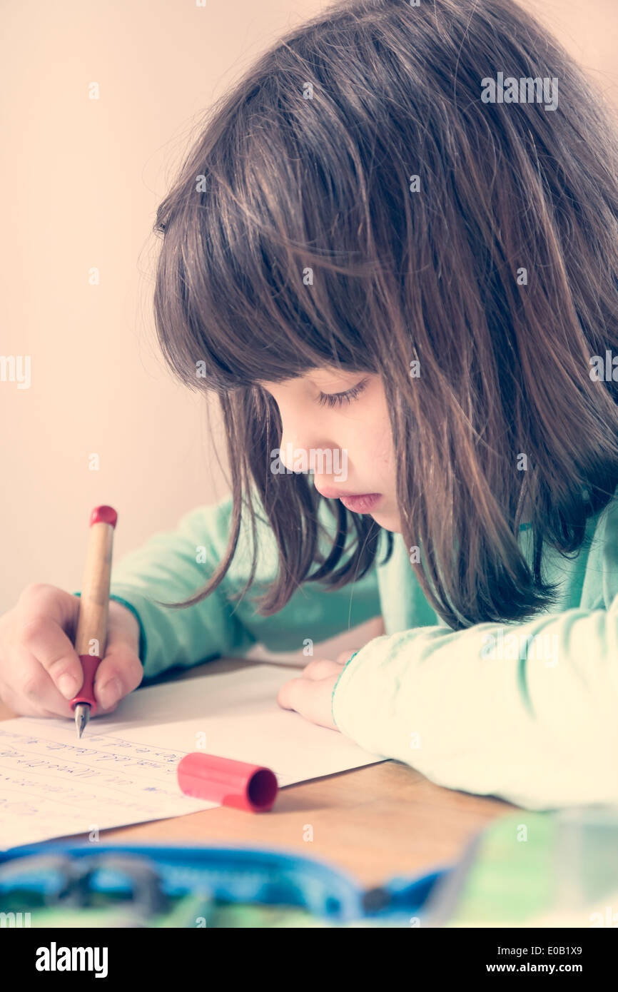 Portrait of little girl doing homework Stock Photo - Alamy