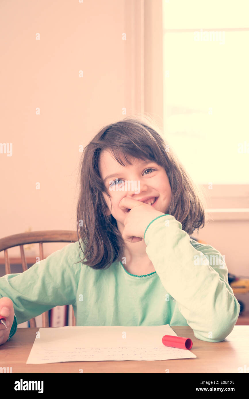 Portrait of smiling little girl doing homework Stock Photo - Alamy